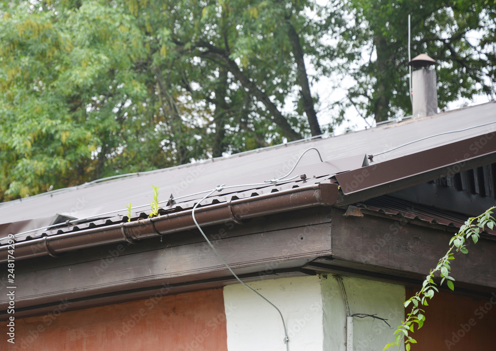 Lightning rod on house rooftop. Close up on house roof lightning ...