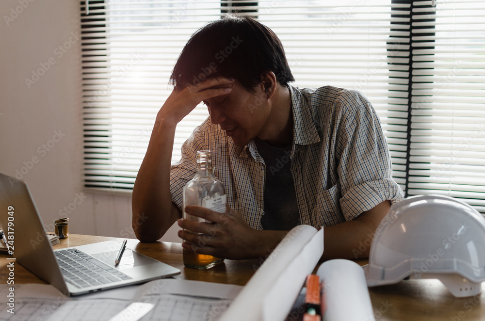 young asian engineer, architect, contractor thinking and worrying about ...