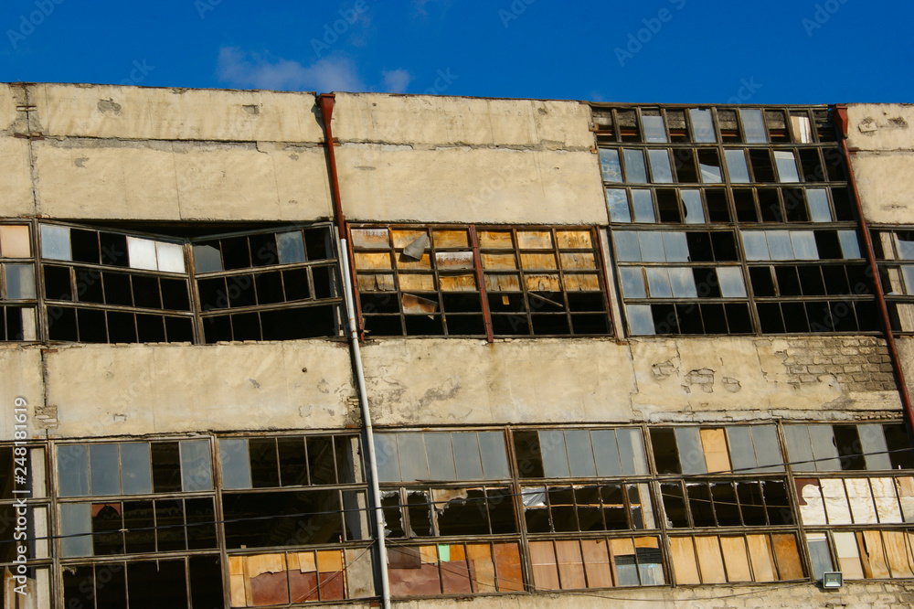 old factory windows. old factory building and the wall with broken ...