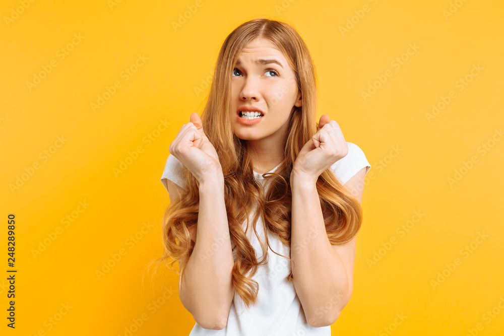 beautiful young girl is worried, a woman with a terrified face, on a ...