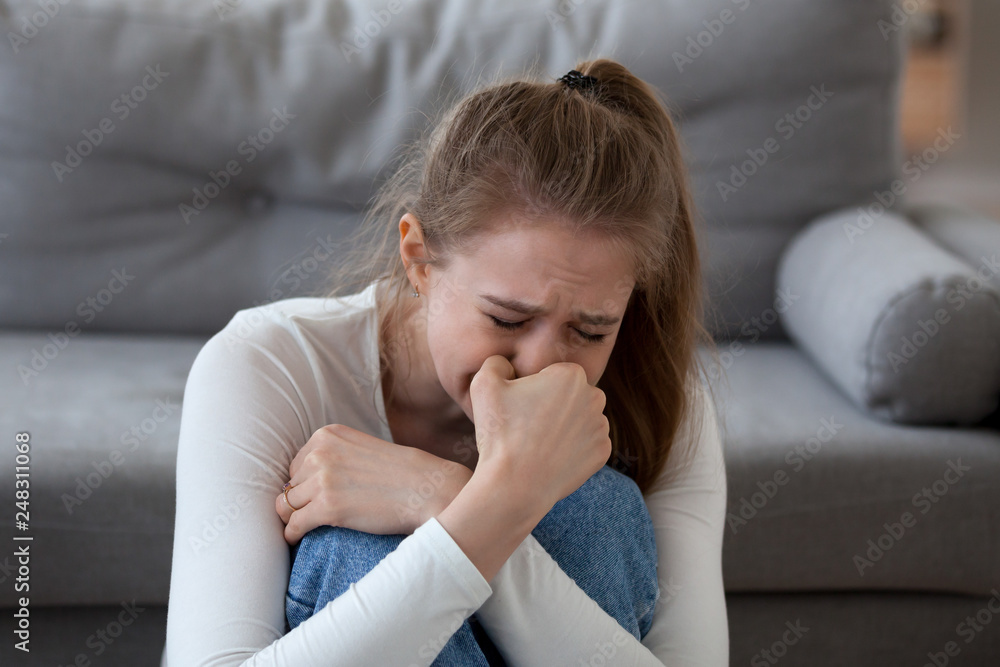 Desperate upset teen girl victim crying alone at home Stock Photo ...