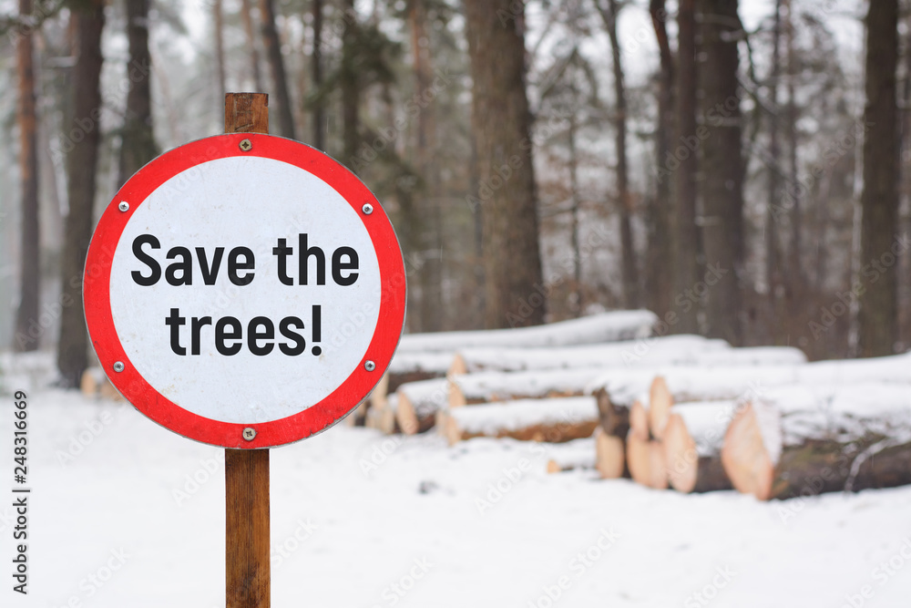 Warning sign SAVE THE TREES against cut logs. Symbol of ecological ...
