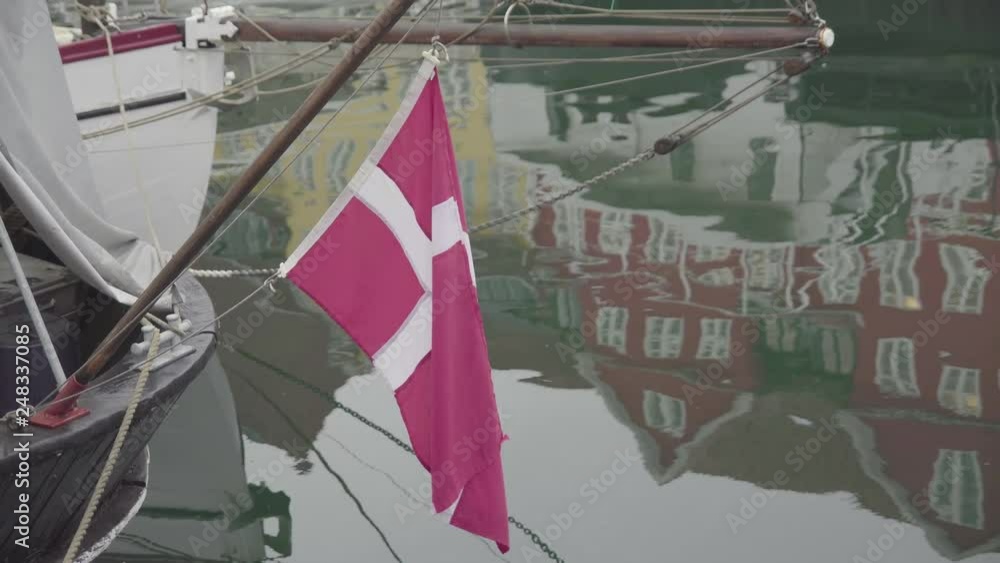 National flag of Denmark hanging on a rope of a ship's nose close-up ...