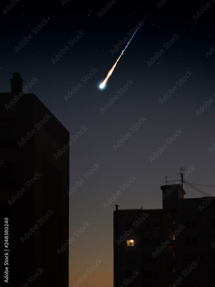 Meteorito cayendo del cielo entre dos edificios Stock Photo | Adobe Stock