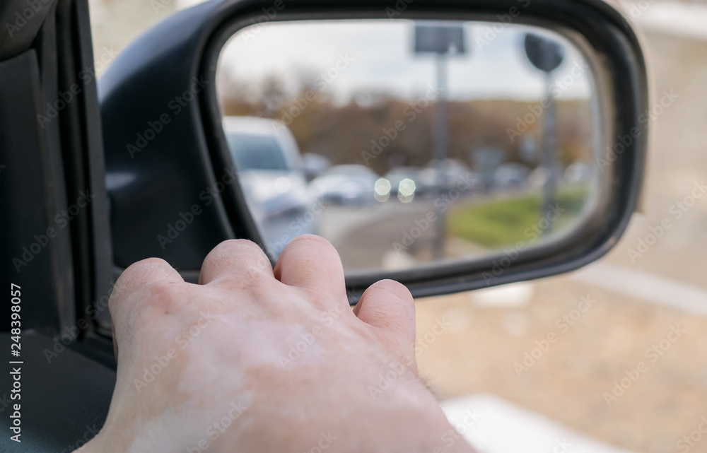 Hand man lying on the car door with a view from the window and with a ...