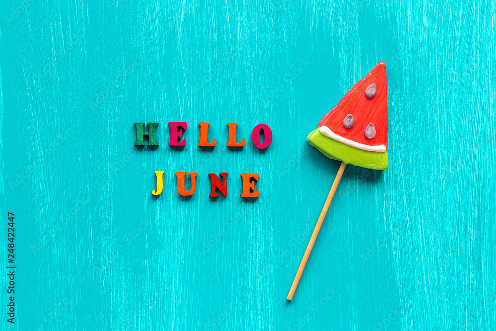 Hello June text from colorful letters and watermelon lollipop on stick ...