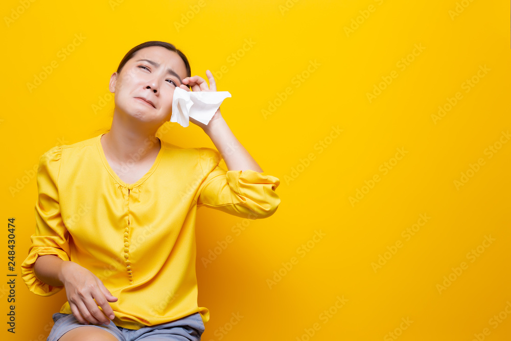Sad woman crying and wipe her tears by tissue paper Stock Photo | Adobe ...