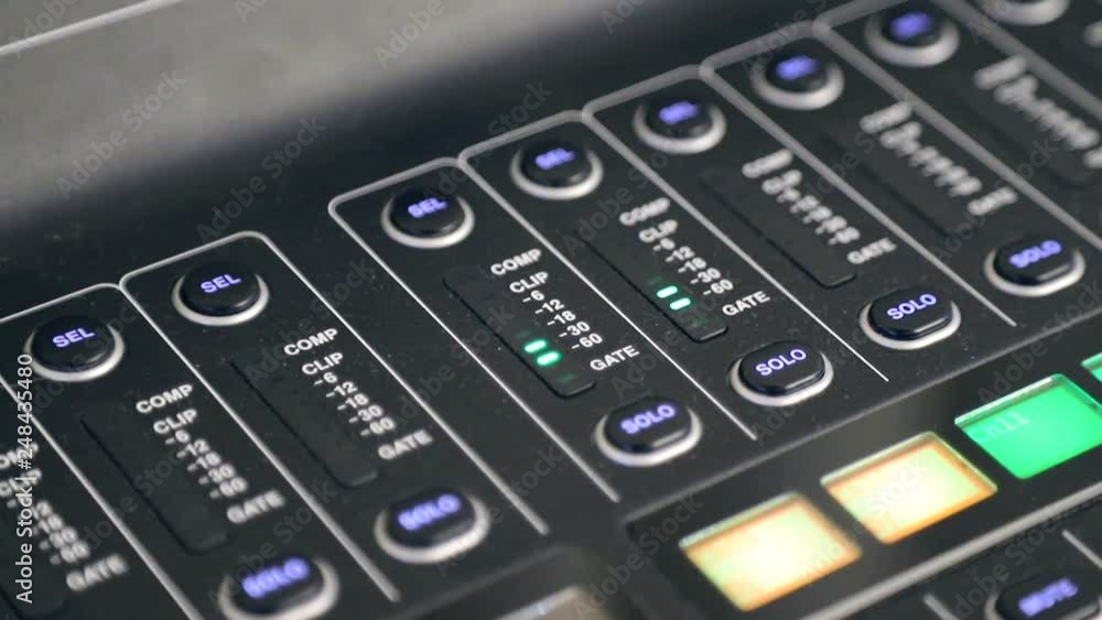 A recording studios audio console. The handles of the device are ...