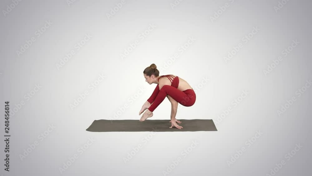 Beautiful woman practices handstand yoga asana Tittibhasana - firefly ...
