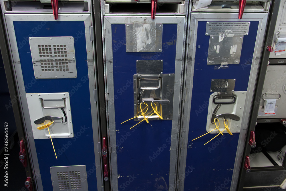 Provision cabinetss on the airplane. Food in box for passengers on the ...