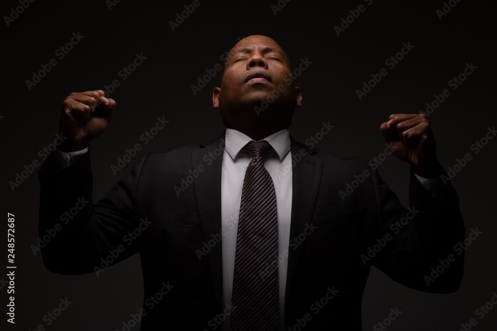 Black Man In Suit Praying