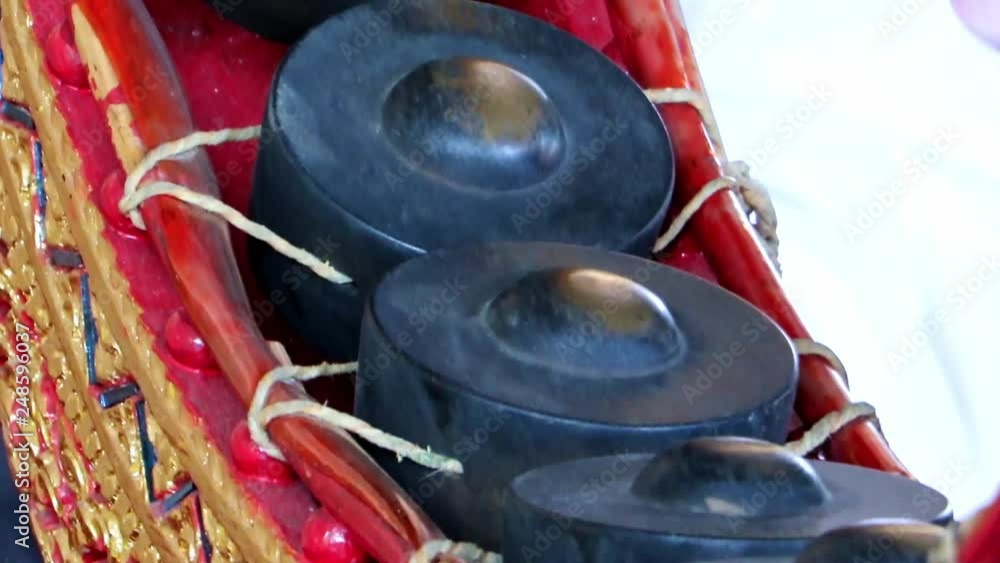 Playing a traditional musical instrument Khong Wong, close up view ...