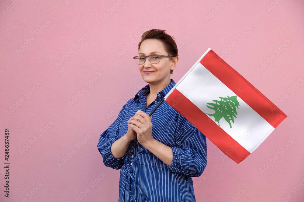 Lebanon flag. Woman holding Lebanese flag. Nice portrait of middle aged ...
