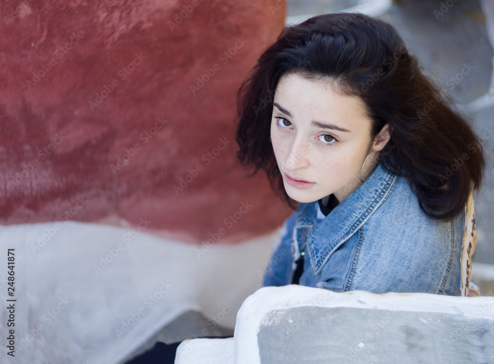 Young Greek girl on the steps of narrow streets in the tourist area of ...