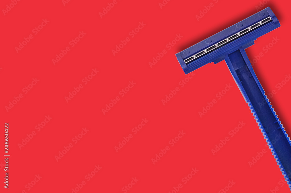 One male disposable plastic razor blue color with two sharp blades on ...