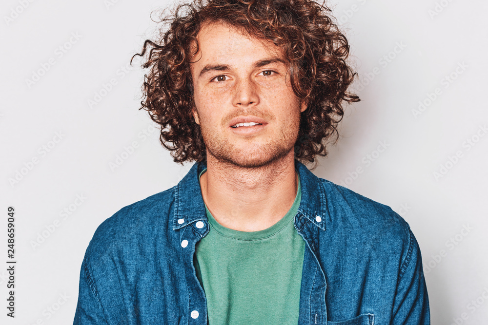 Serious man posing for advertisement, looking to the camera, isolated ...