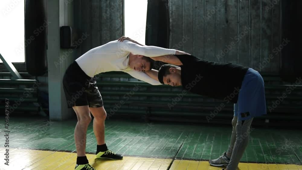 Vidéo Stock Two men engaged in boxing doing stretching exercises for ...