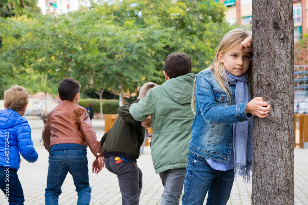 Kids playing hide and seek on the street Stock Photo | Adobe Stock