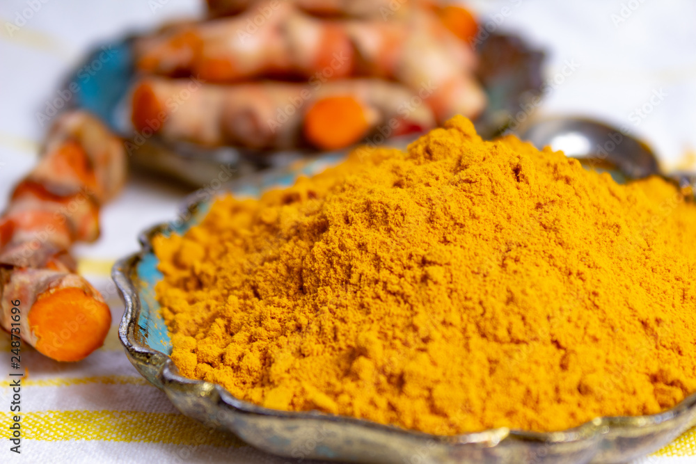 Fresh turmeric or curcuma root and dried powder, wildly used in Asia ...