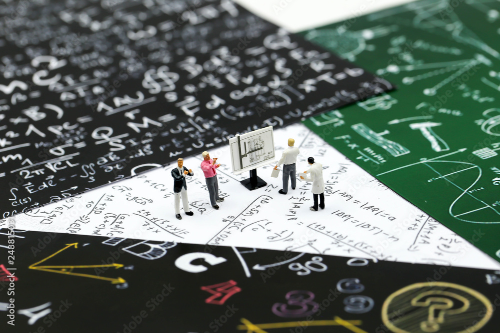 Miniature people : teacher and friend with Math problems on graph paper ...