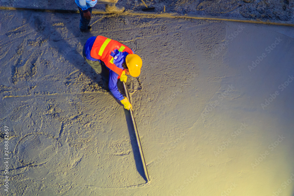 Mason worker leveling concrete with trowels, mason hands spreading ...