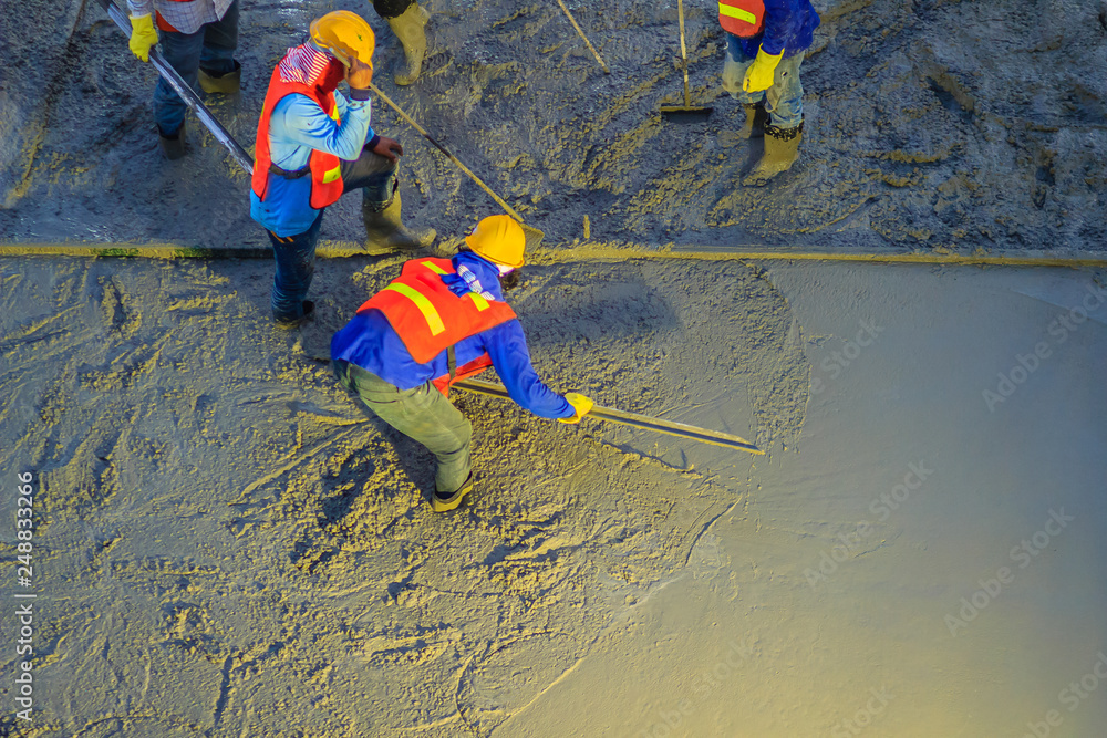 Mason worker leveling concrete with trowels, mason hands spreading ...