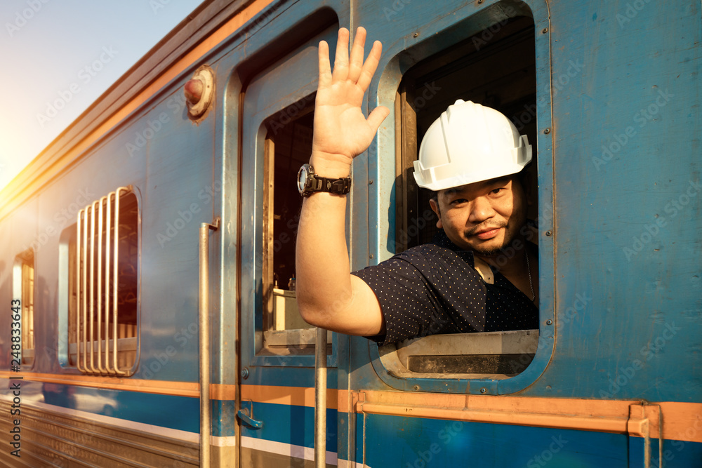 Train driver checking engine of train and gesture the hand to already ...