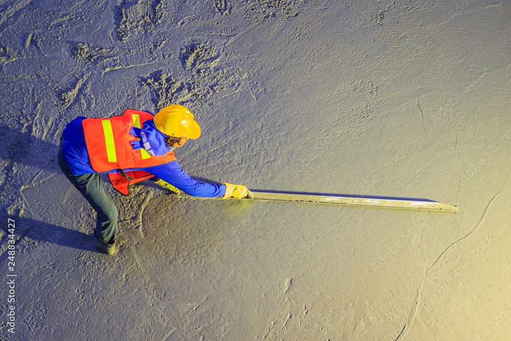 Mason worker leveling concrete with trowels, mason hands spreading ...
