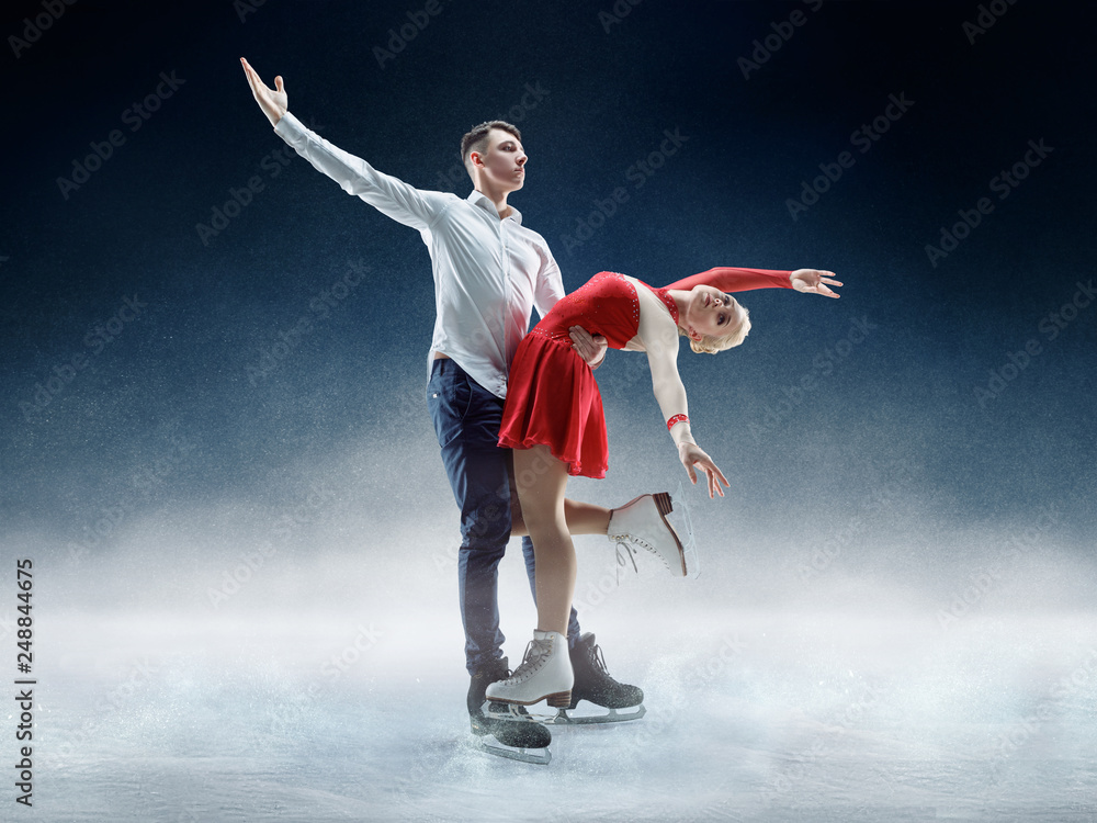 Professional man and woman figure skaters performing show or ...