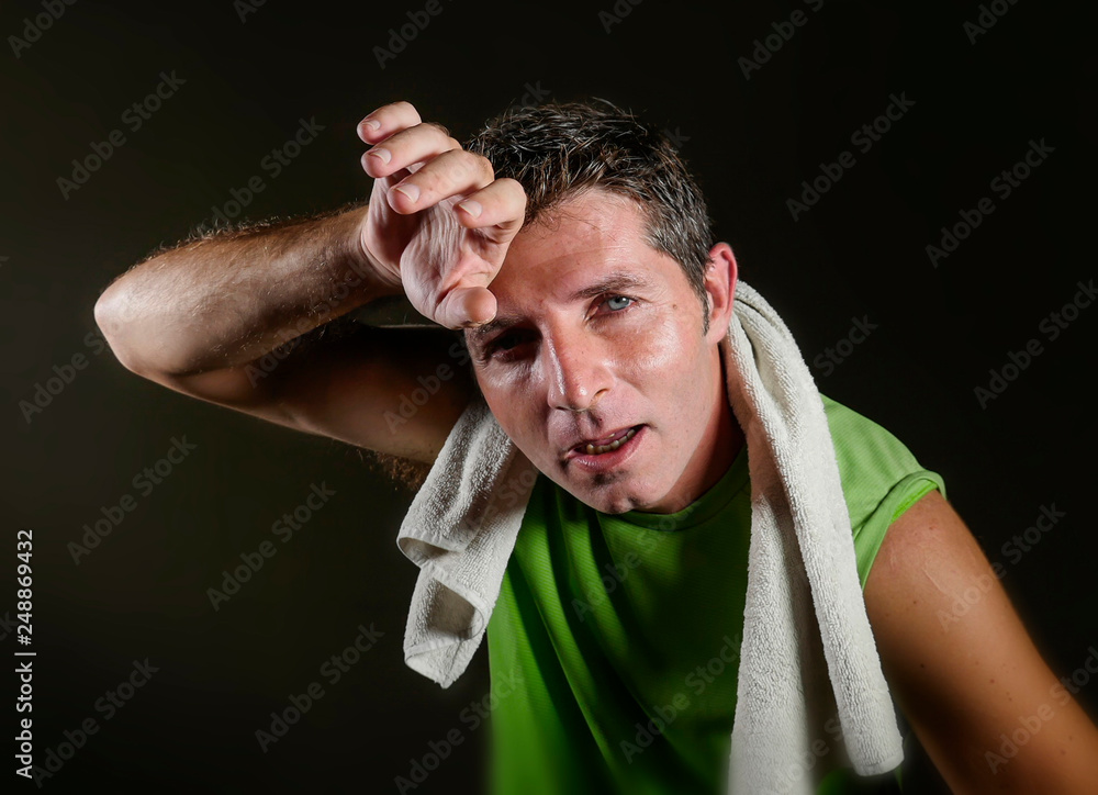 young tired and exhausted sport man drying sweat with towel all sweaty ...