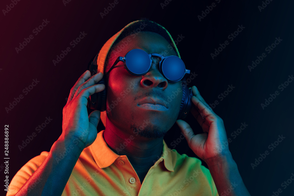 The young handsome serious sad hipster man listening music with ...