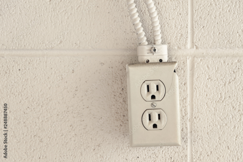 Old rustic North American electrical outlet on a white brick wall Stock ...