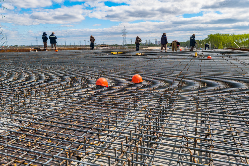 reinforcement cage of the bridge span. workers make the frame of ...
