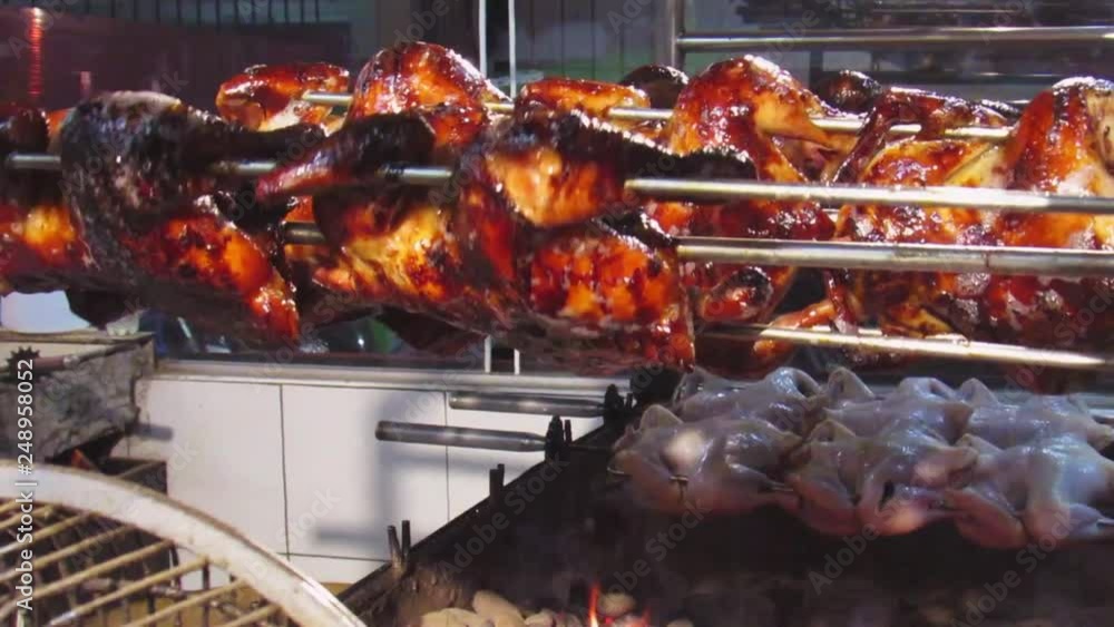 Crispy Barbecue Chickens Being Cooked On A Rotisserie Over Fire And ...