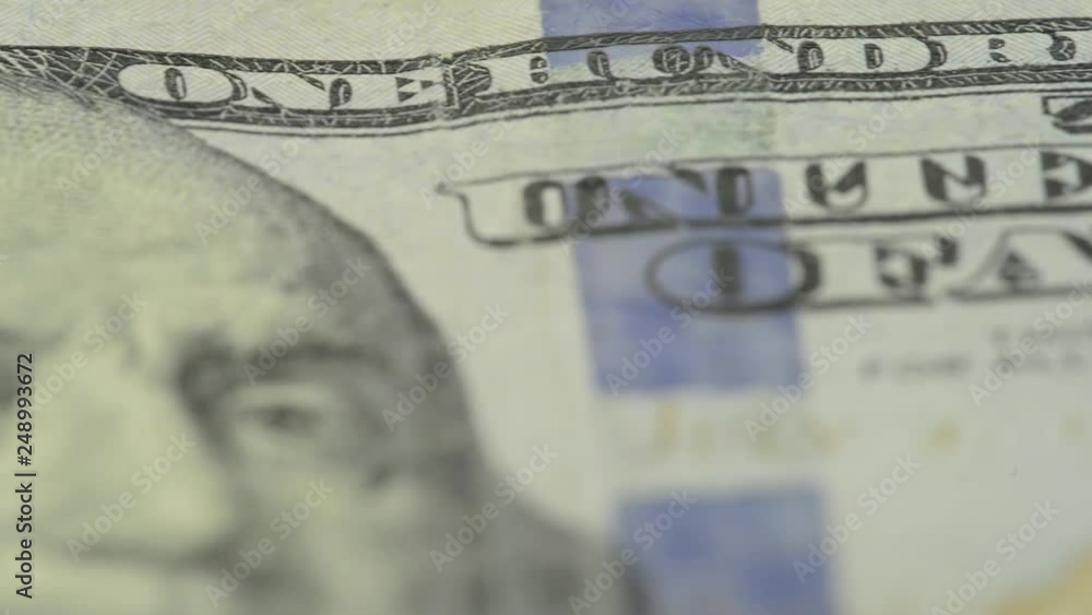 One hundred dollar bill with a slow pan from 'one hundred' at top of ...