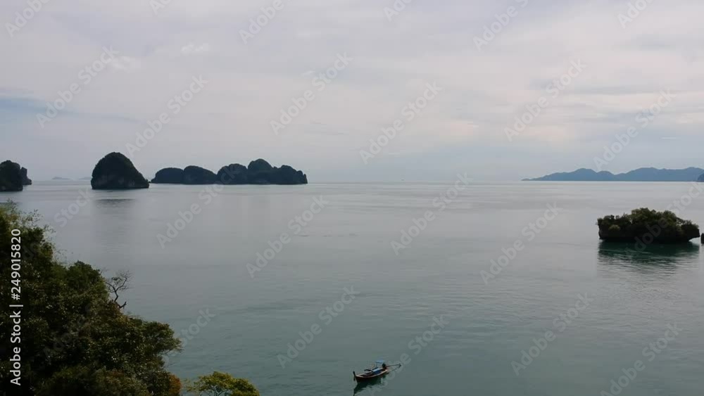 Drone footage of longtail boat navigating around islands of Thailand ...
