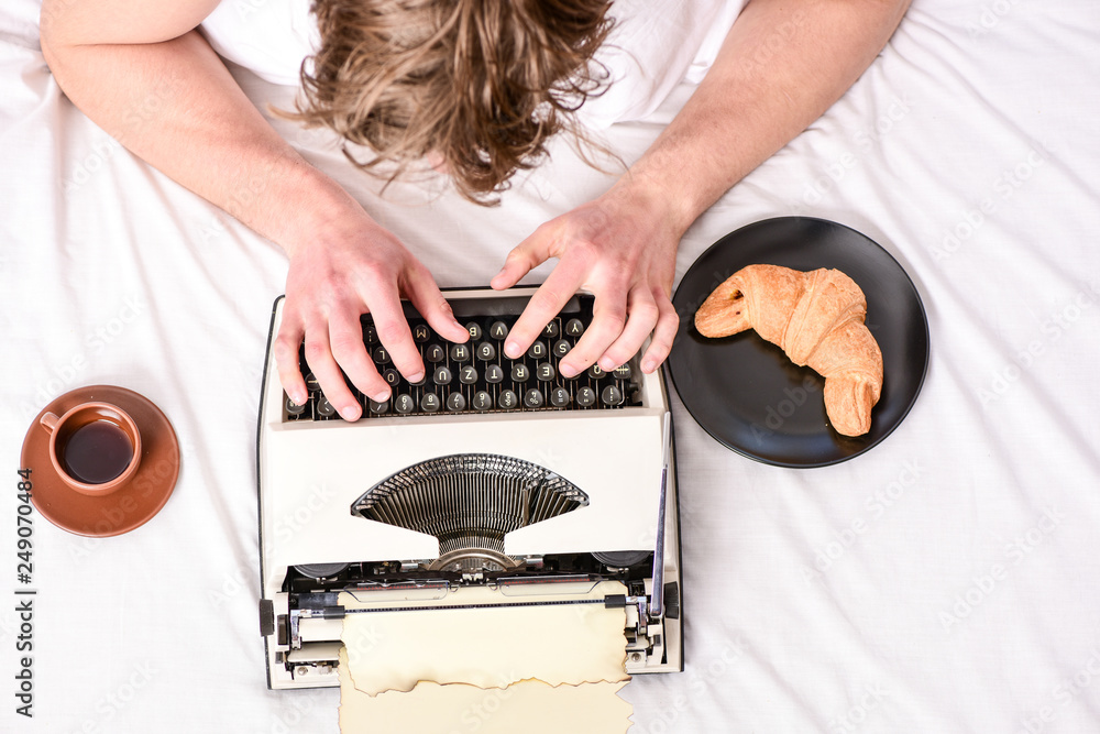 Man typing retro writing machine. Old typewriter on bedclothes. Male ...