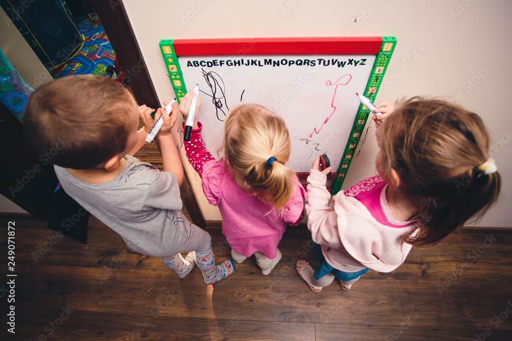 Children drawing a pictures learning a letters playing together using ...