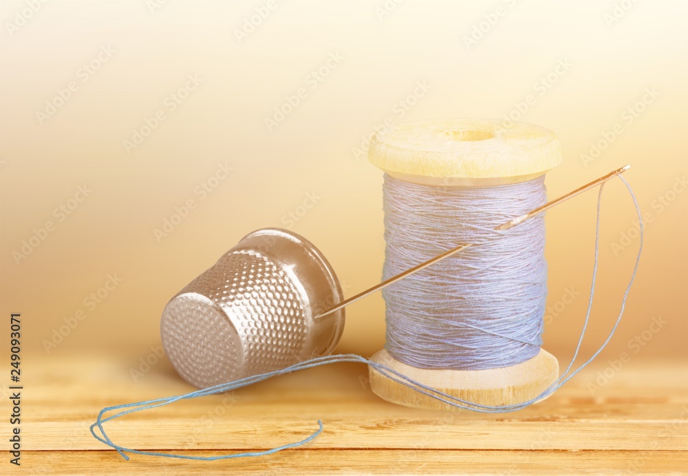 Spool of Thread and Needle Stock Photo | Adobe Stock