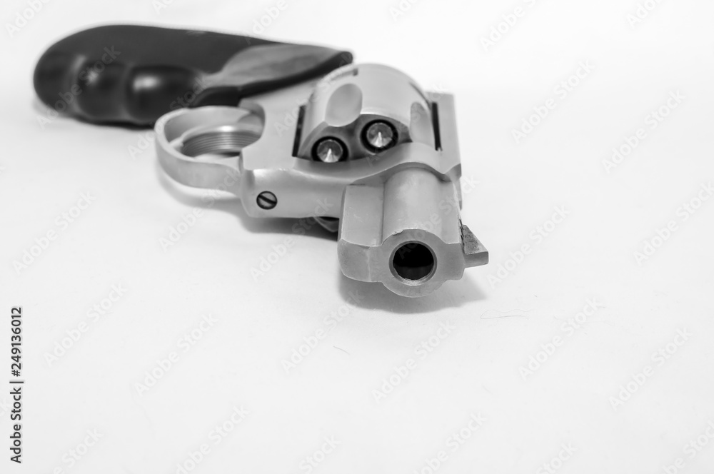 A loaded 357 magnum revolver on its side on a white background shown in ...
