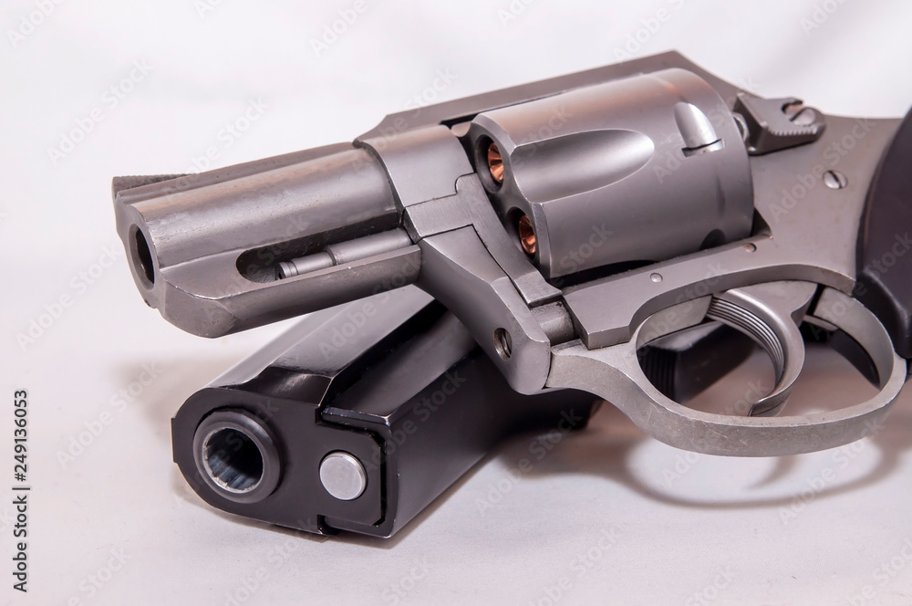 Two handguns, a 40 caliber pistol and a 357 magnum revolver on a white ...