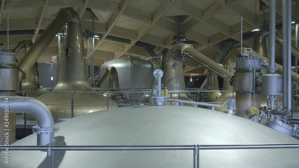 Interior pipework, copper stills and mash tuns highlighting the ...