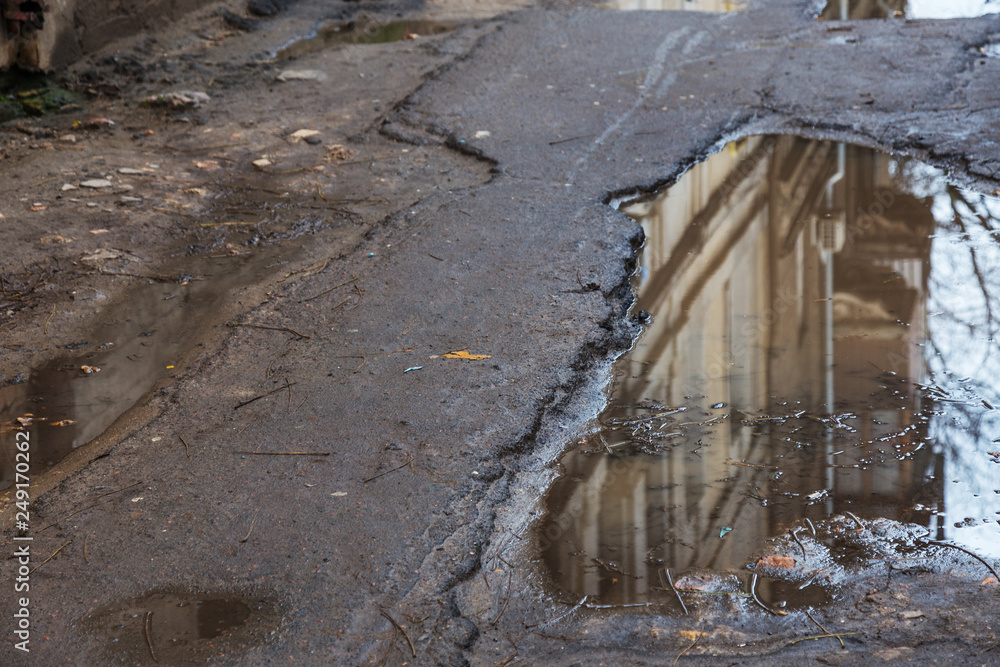 Very bad quality road with potholes. Hole in asphalt, bad asphalt. Pit ...