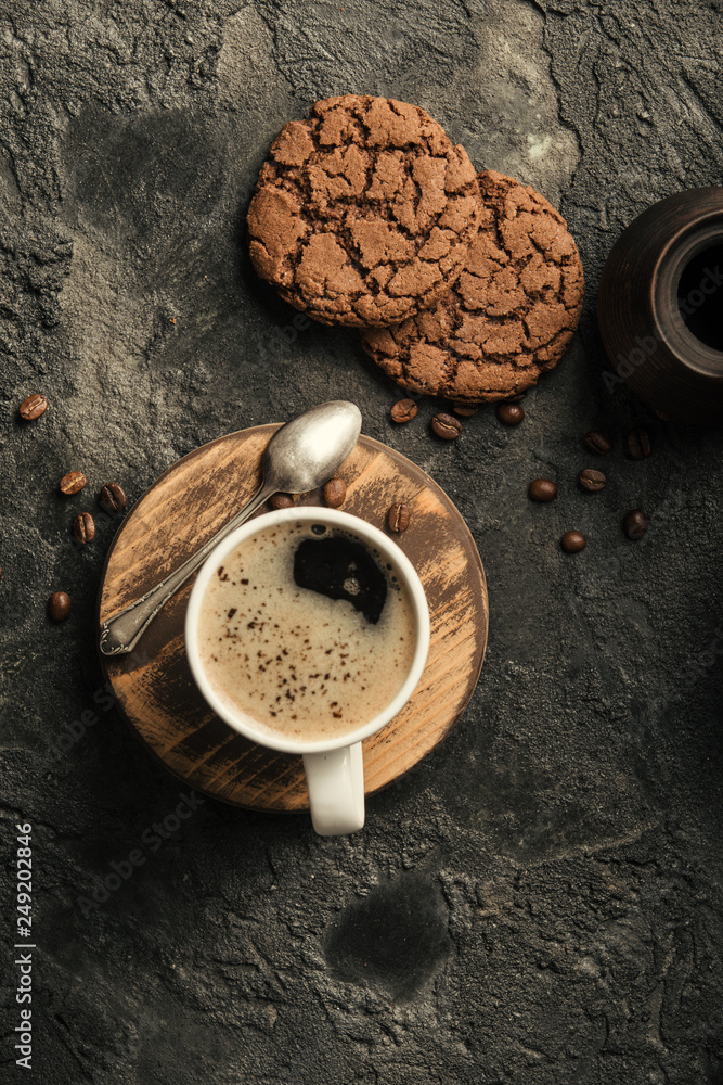 Black fried coffee beans in cafe with cookie and cake on dark textured ...