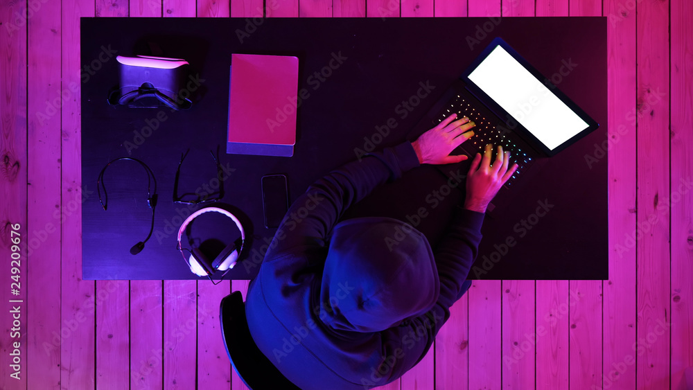 Cybercrime, hacking and technology concept - male hacker in dark room ...