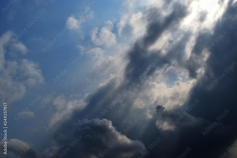 Cumulonimbus cloud formations on tropical sky with sunbeam light shoot ...