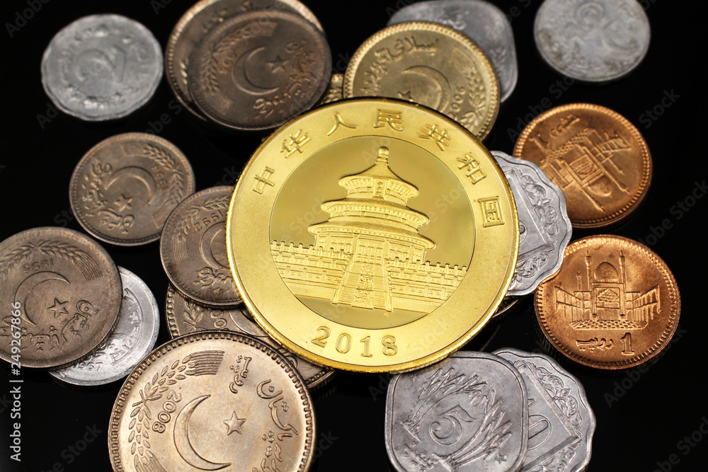 A macro image of a Chinese one ounce coin and assorted coins from ...
