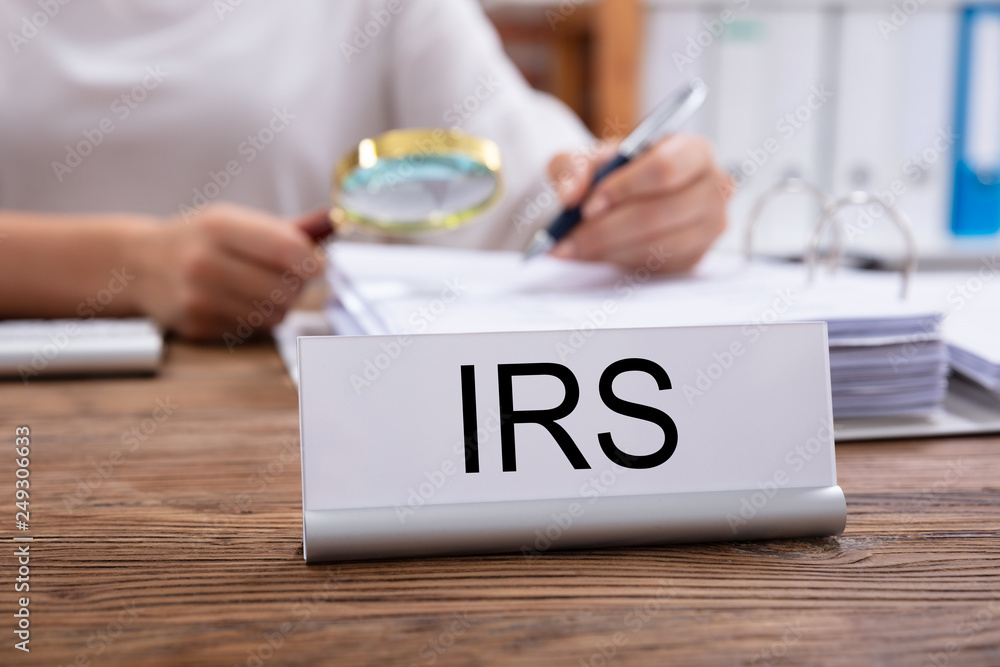 Nameplate With IRS Title Kept On Businesswoman's Desk Stock Photo ...