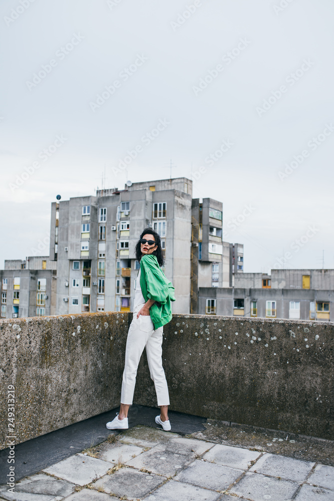 Beautiful woman fashion model posing on building rooftop. Stock Photo ...