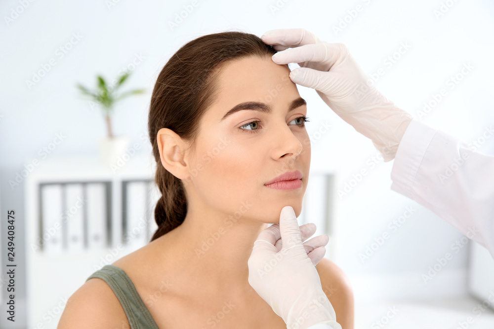 Dermatologist examining patient's face in clinic. Skin cancer checkup ...